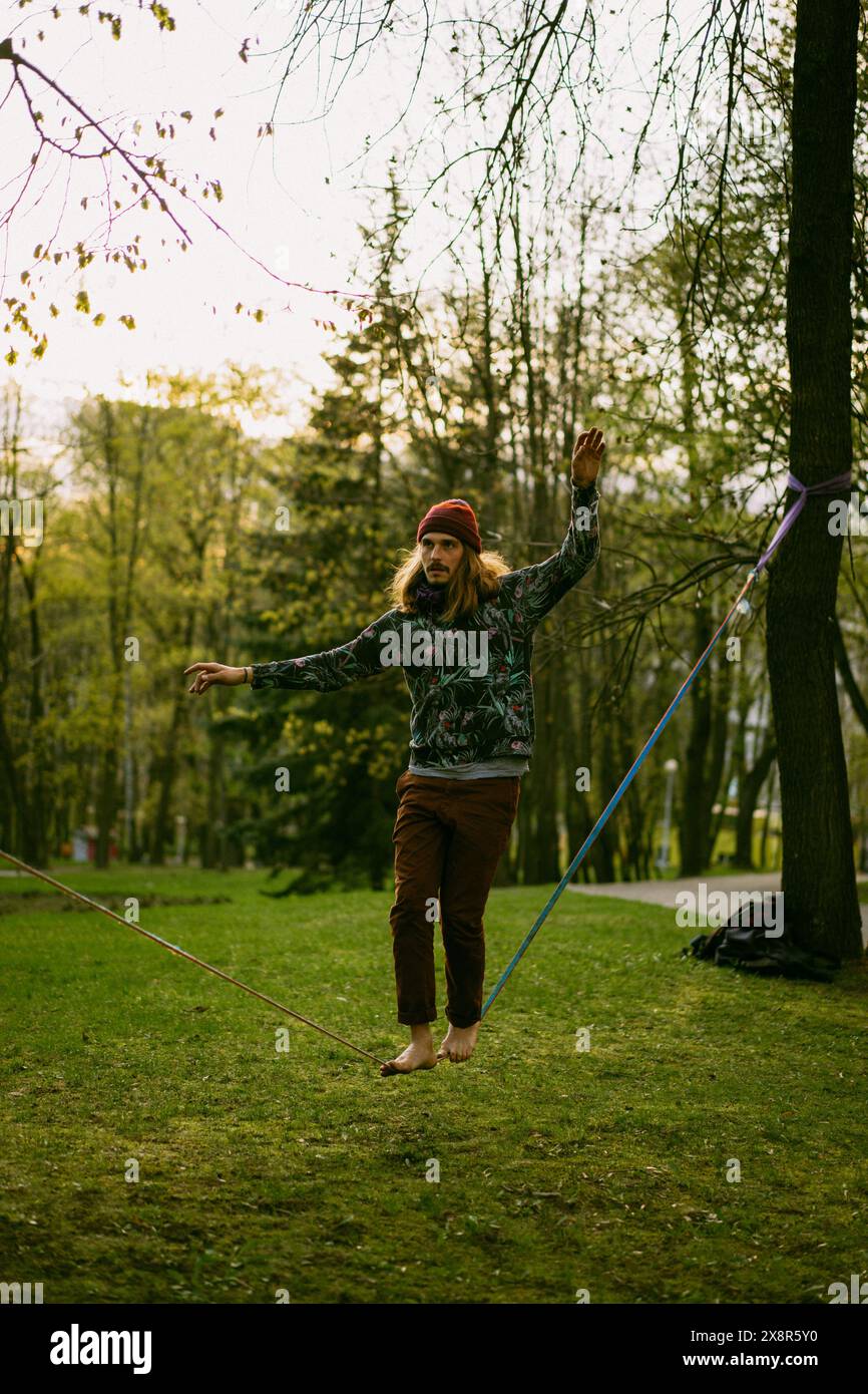 Athletic man trains on a slackline Stock Photo - Alamy