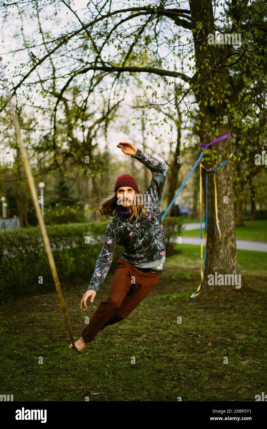 Athletic man trains on a slackline Stock Photo - Alamy