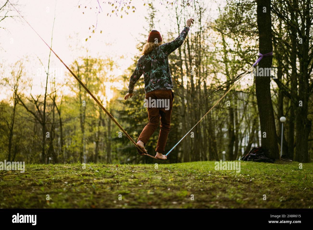 Athletic man trains on a slackline Stock Photo - Alamy
