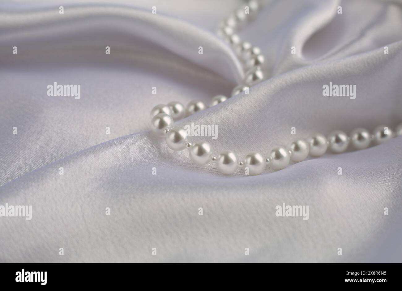 Beautiful background of white pearls on satin Stock Photo - Alamy