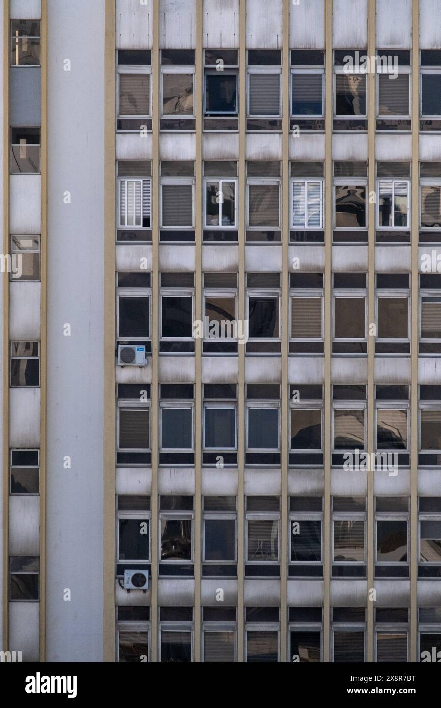 Photograph of a building facade with a repetitive pattern of windows in ...