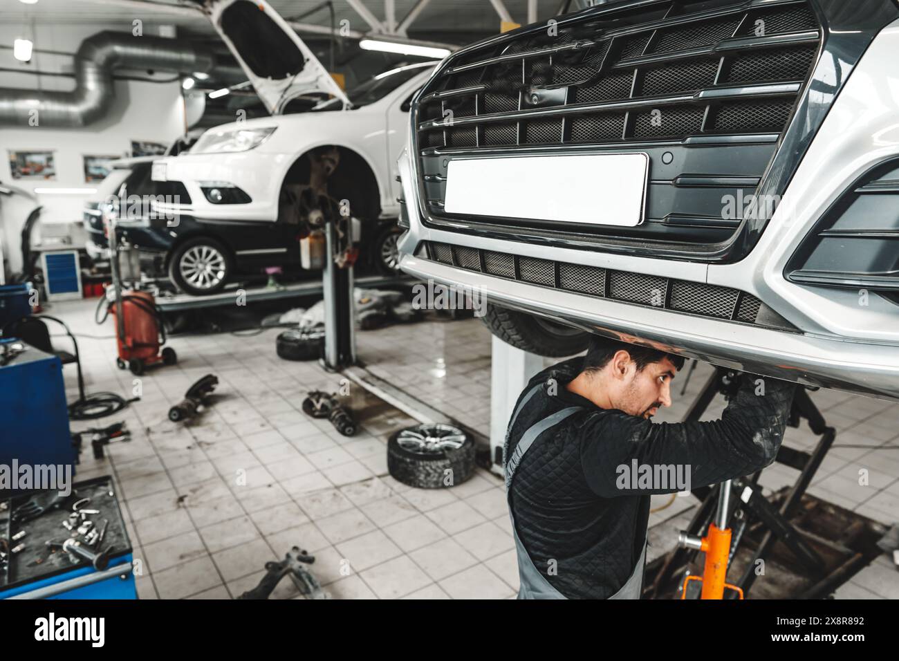 Auto mechanic checking running gear hi-res stock photography and images ...