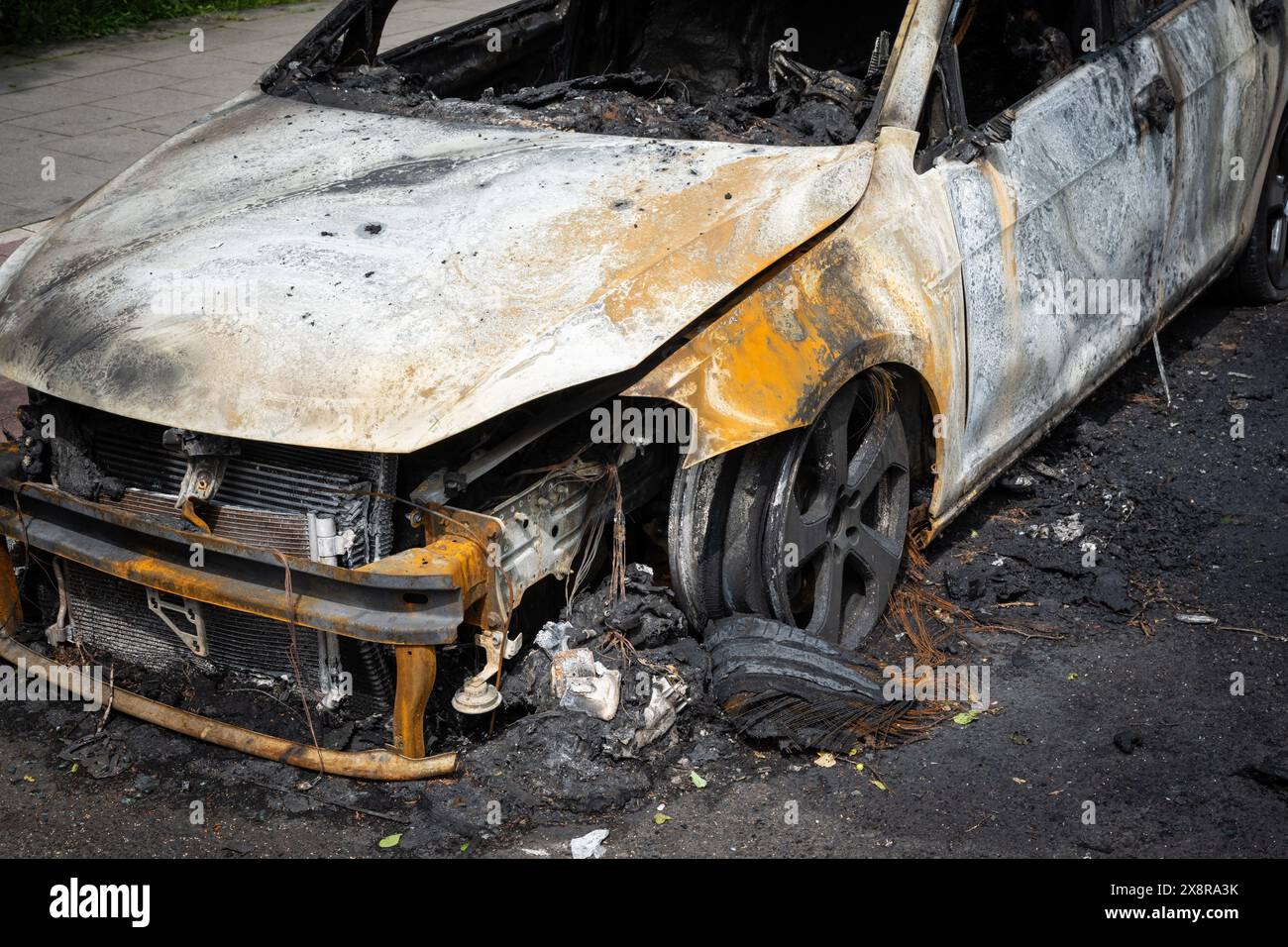 A burnt-out car with destroyed interior and engine, view over the hood ...