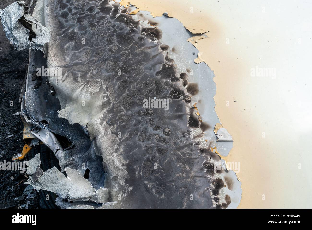 Fire has burned part of the white lacquered aluminum surface and turned ...