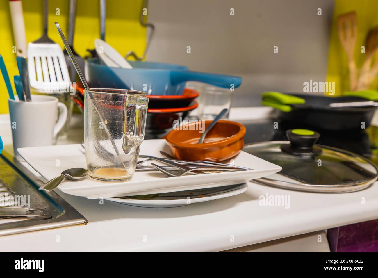 A messy kitchen counter with dirty dishes and glasses after dinner ...