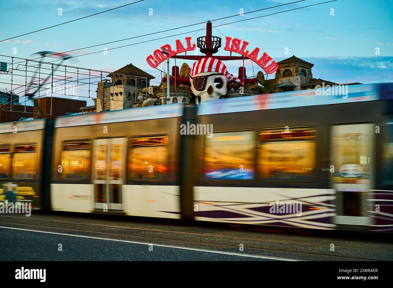 Blackpool tram passing Coral Island amusements at sunset Stock Photo ...