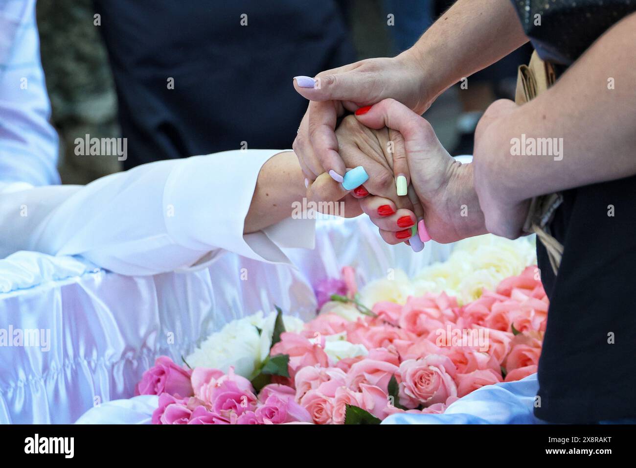Non Exclusive: ODESA, UKRAINE - MAY 26, 2024 - Women hold the hand of ...