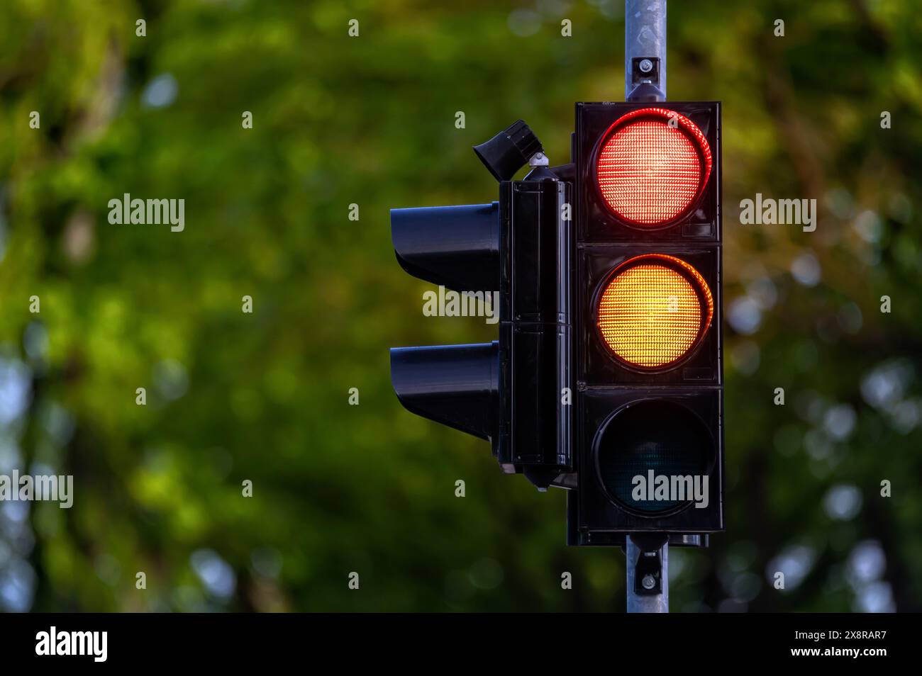 Stoplights displaying red and yellow signals against a background of ...