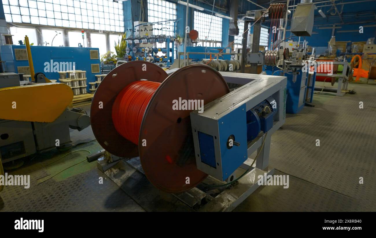Rotating coil with wires in factory. Creative. Winding cable on to coil ...