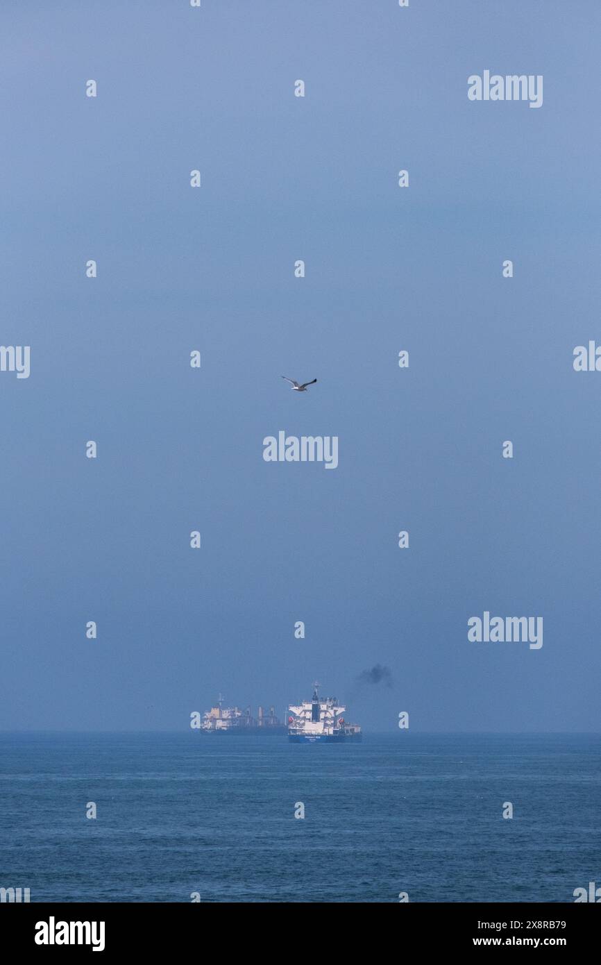 A freight ship sailing on the Atlantic Ocean near the port of ...