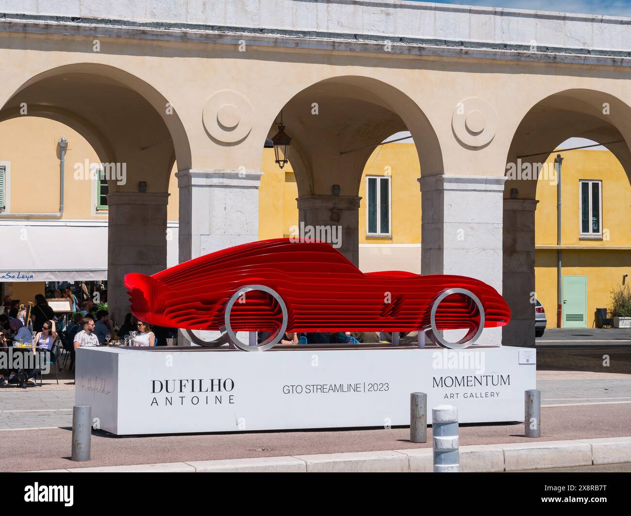 Colourful art representation of a red car on a plinth in Nice old town ...