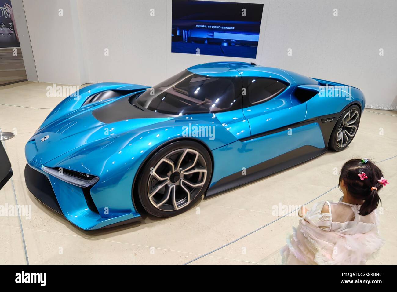 XI'AN, CHINA - MAY 26, 2024 - Citizens consult the Nio EP9 electric ...