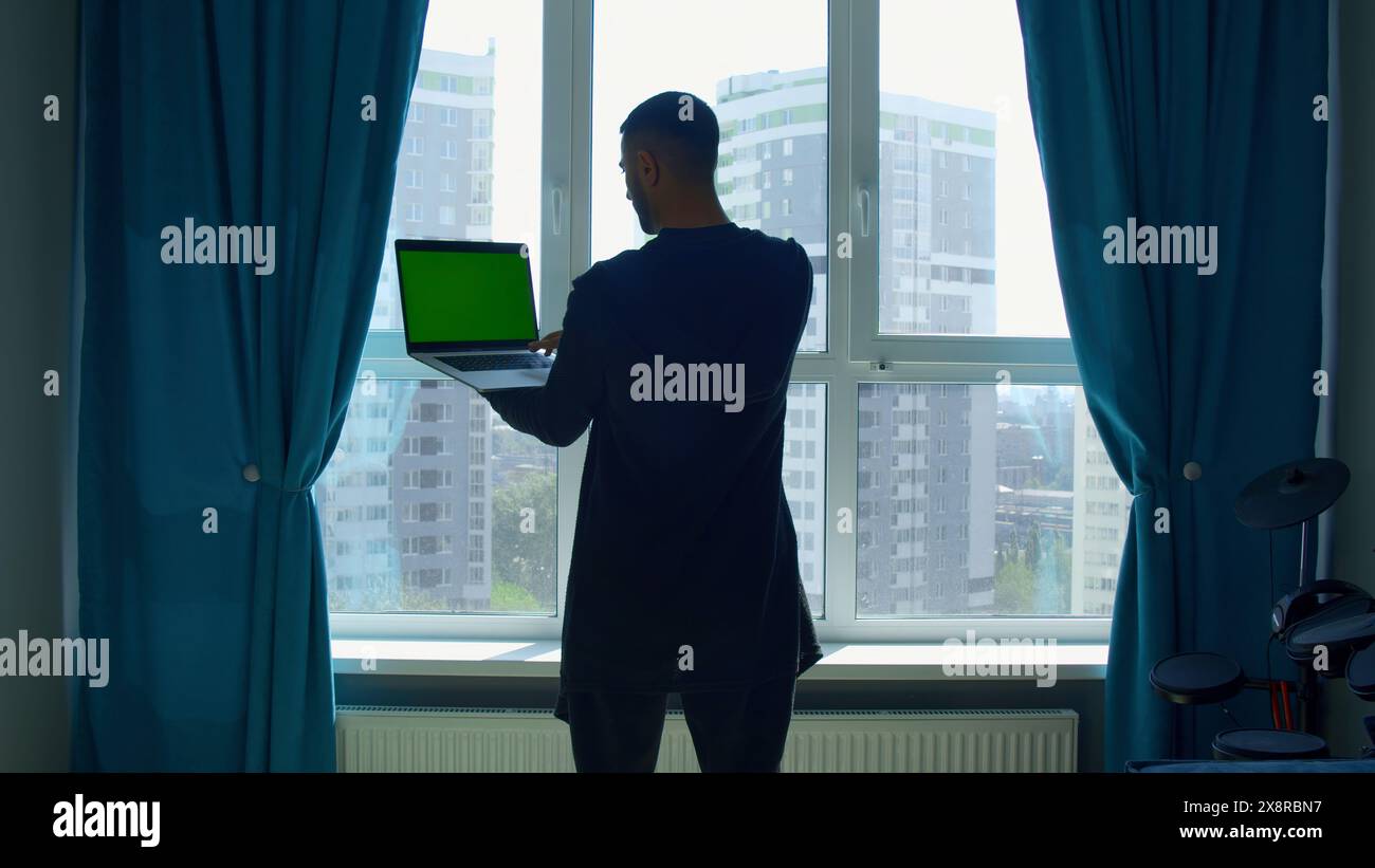 Businessman standing window looking distance hi-res stock photography ...