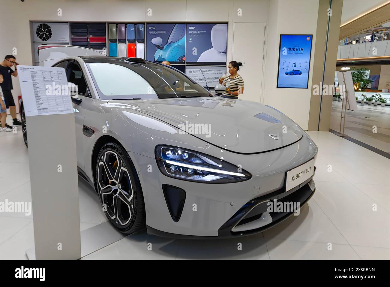 XI'AN, CHINA - MAY 26, 2024 - Citizens consult a xiaomi su7 new energy ...