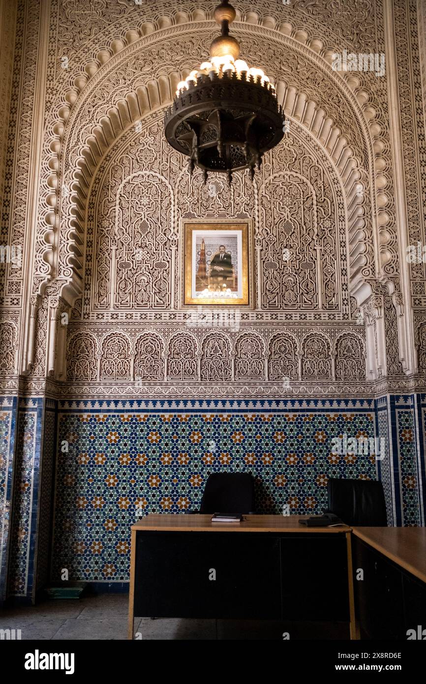 A portrait of King Mohammed VI with Moroccan flags at the Mahkama of ...