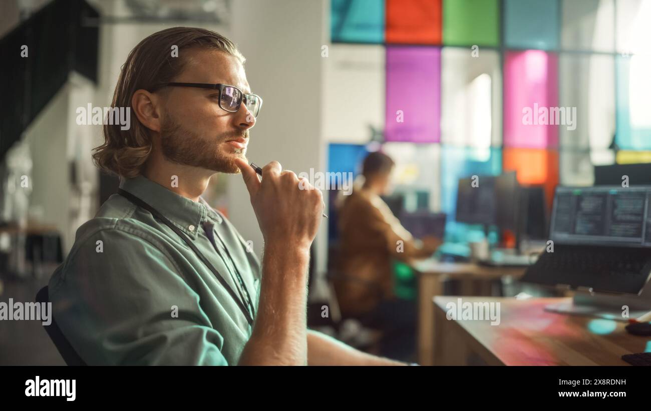 Professional Male Programmer Writing Code On Desktop Computer With