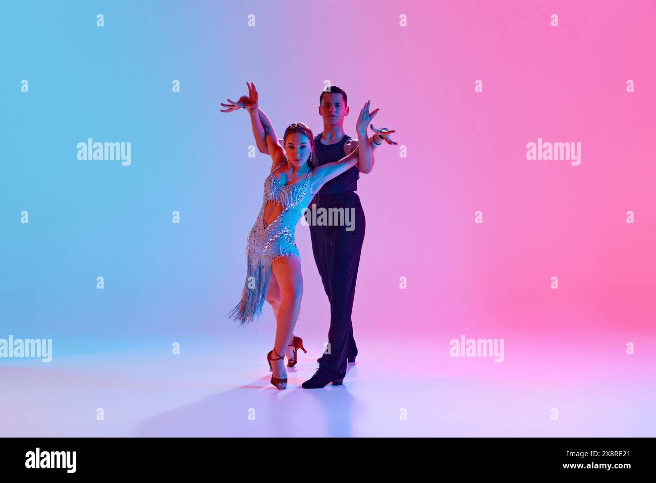 Pair of ballroom dancers performing dramatic pose, with woman in ...