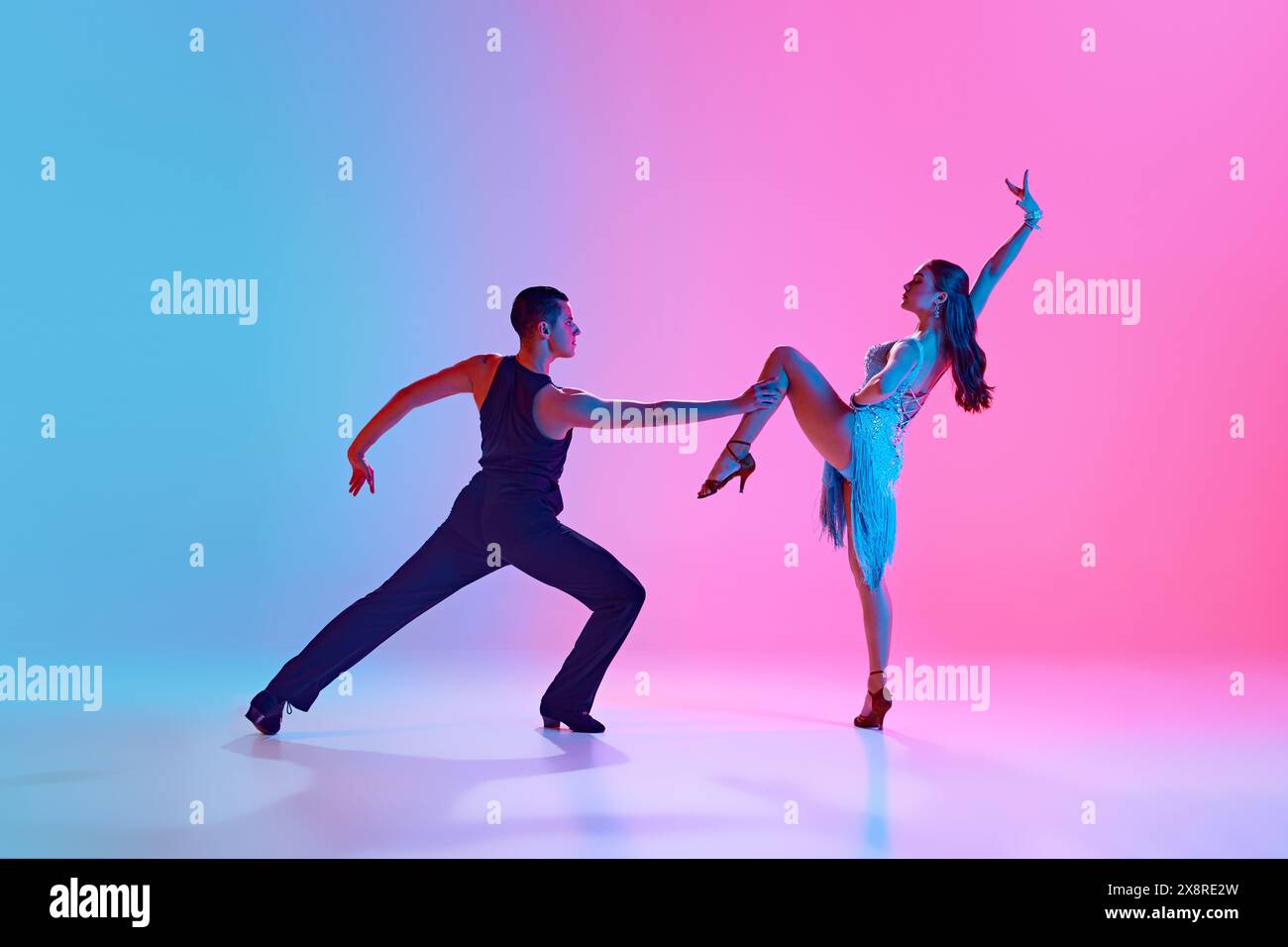 Man and woman, ballroom dancers, performing full of feelings tango ...