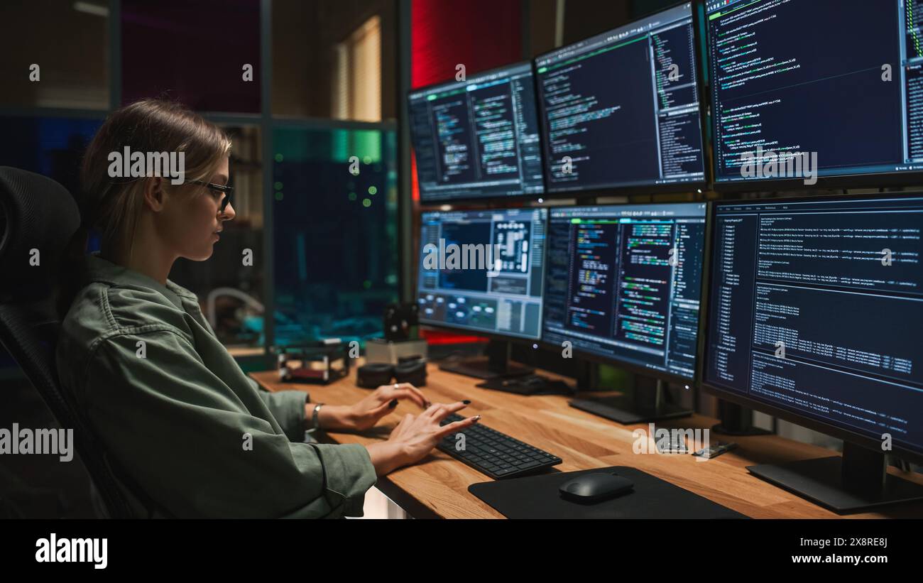 Female Cyber Security Specialist Writing Code On Deskop Computer with Six Displays in Dark ...