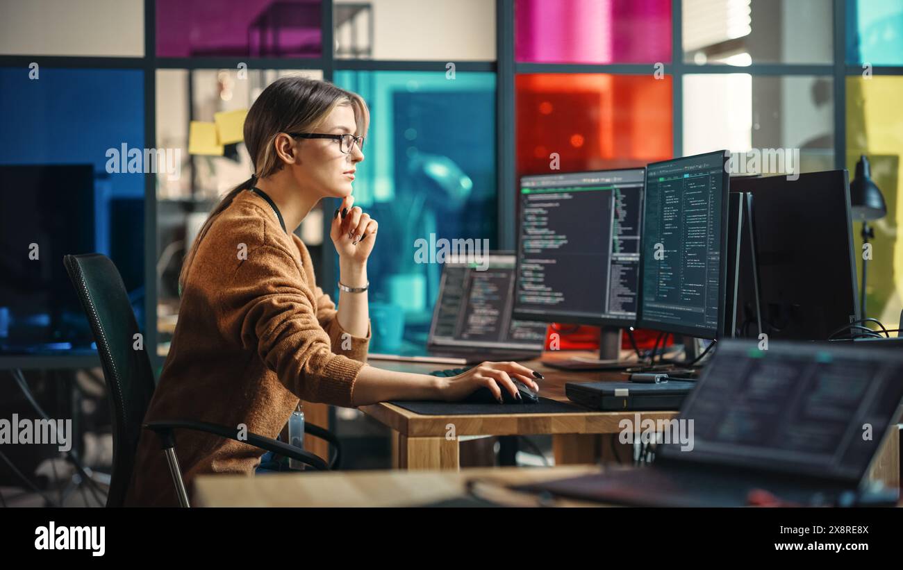 Female Junior Software Engineer Writes Code on Desktop Computer With ...