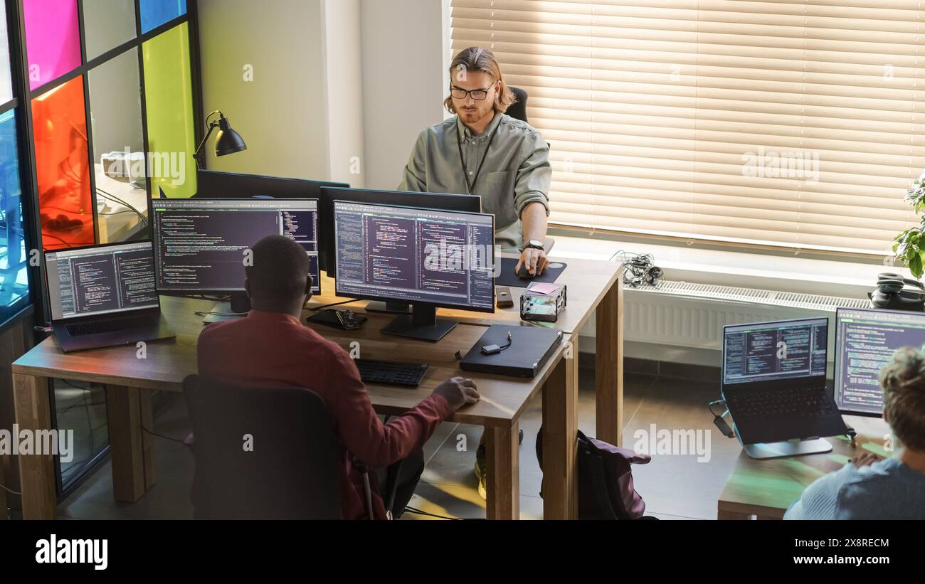 Diverse Colleagues Writing Code on Desktop Computers With Professional Multiple Monitors Setup ...