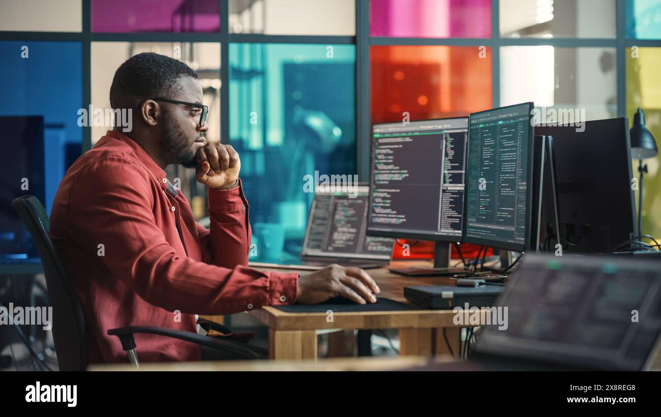 Male Senior Software Developer Writing Code On Desktop Computer With ...