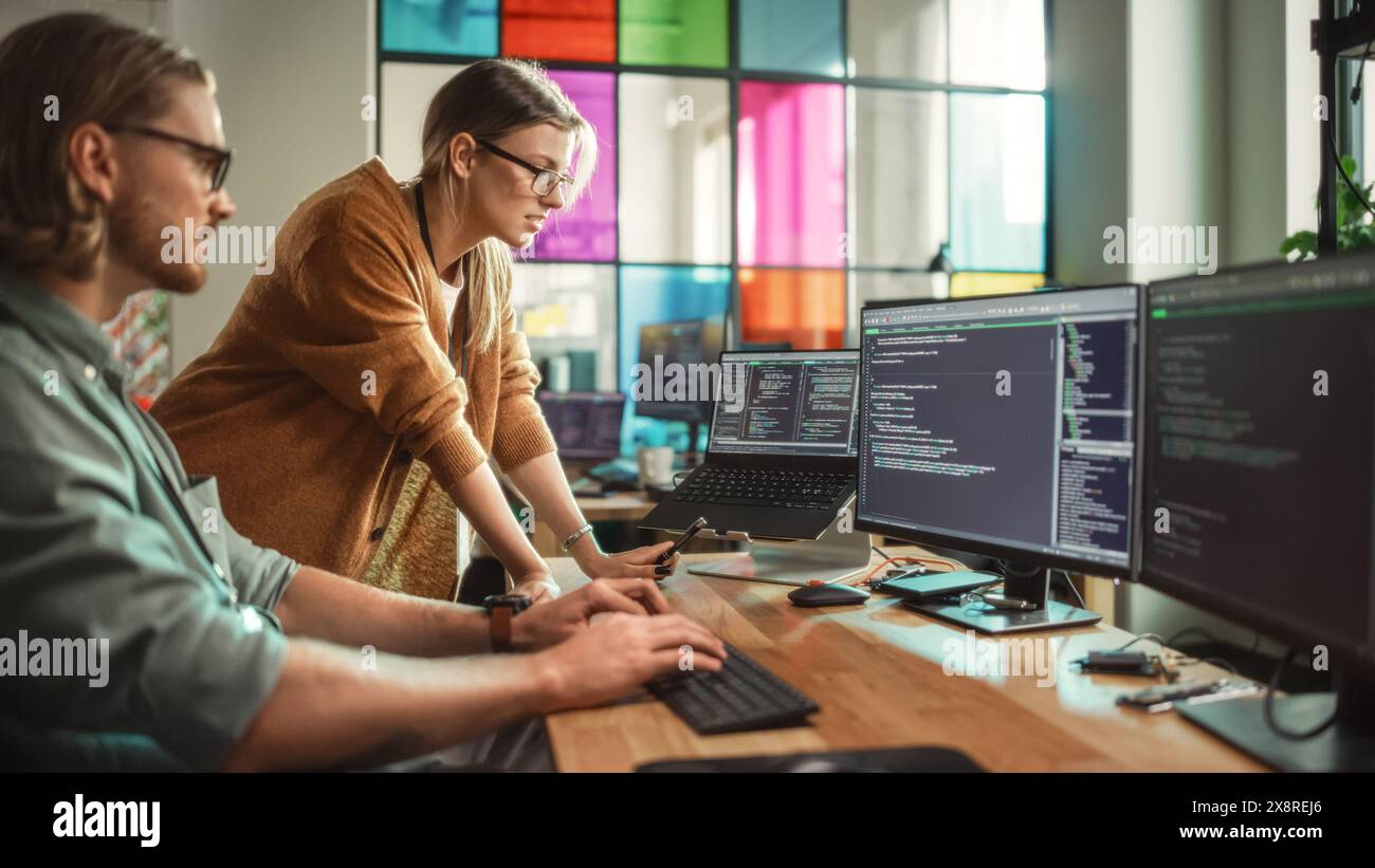 Male Data Scientist and Female Developer Working With Errors in Code on Desktop Computer in ...