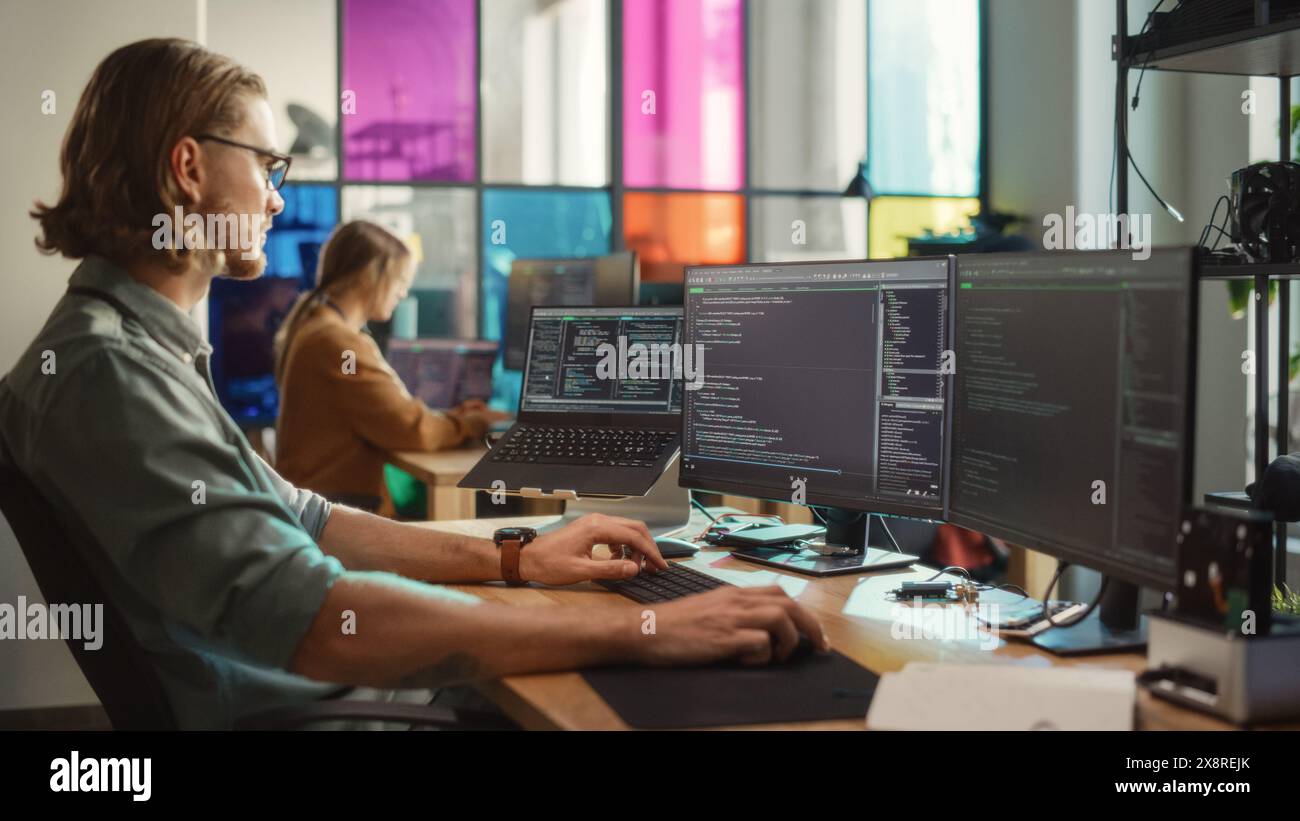 Developer using multiple displays coding hi-res stock photography and images - Alamy