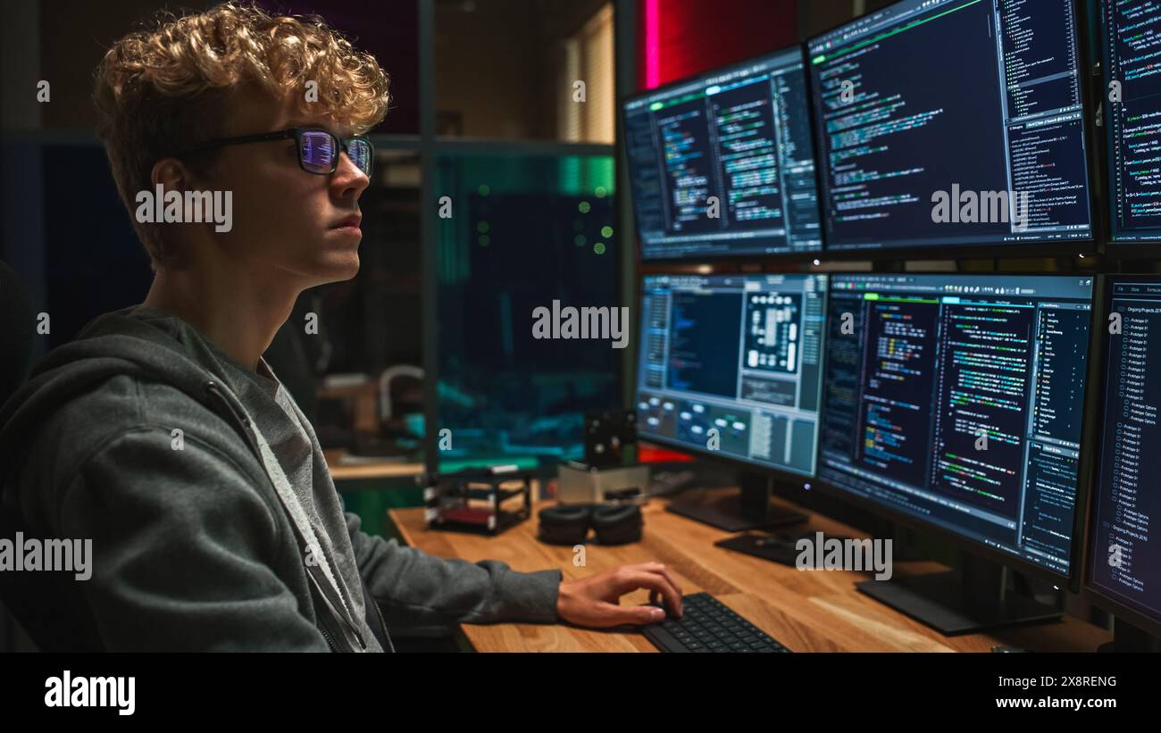 Male Cyber Security Intern Writing Code on Desktop PC With Professional ...