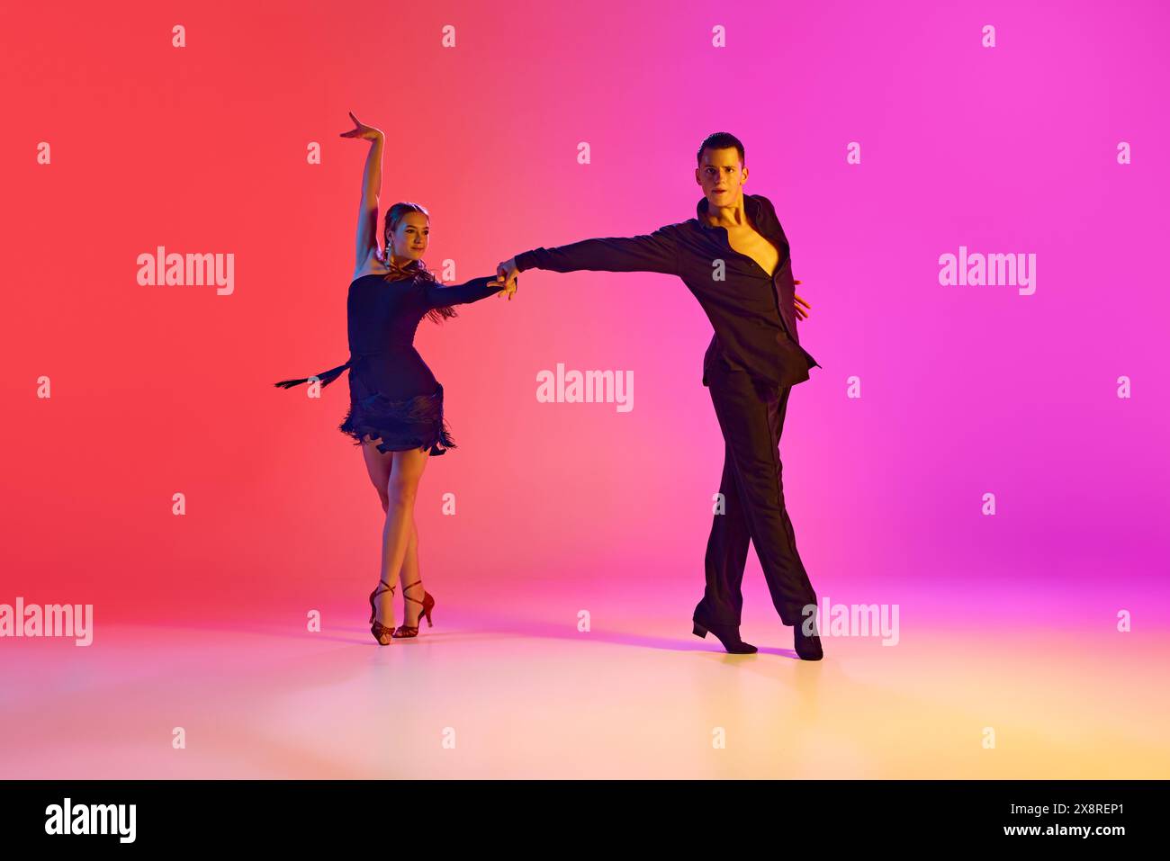 Talented ballroom dancers in black stages costumes dancing ...