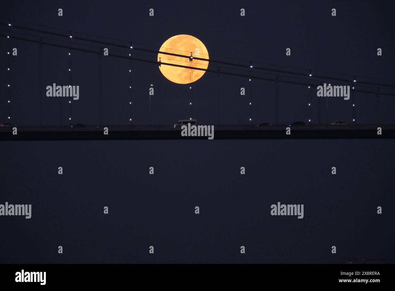 Full moon over Bosphorus bridge at night. The bright and full moon ...