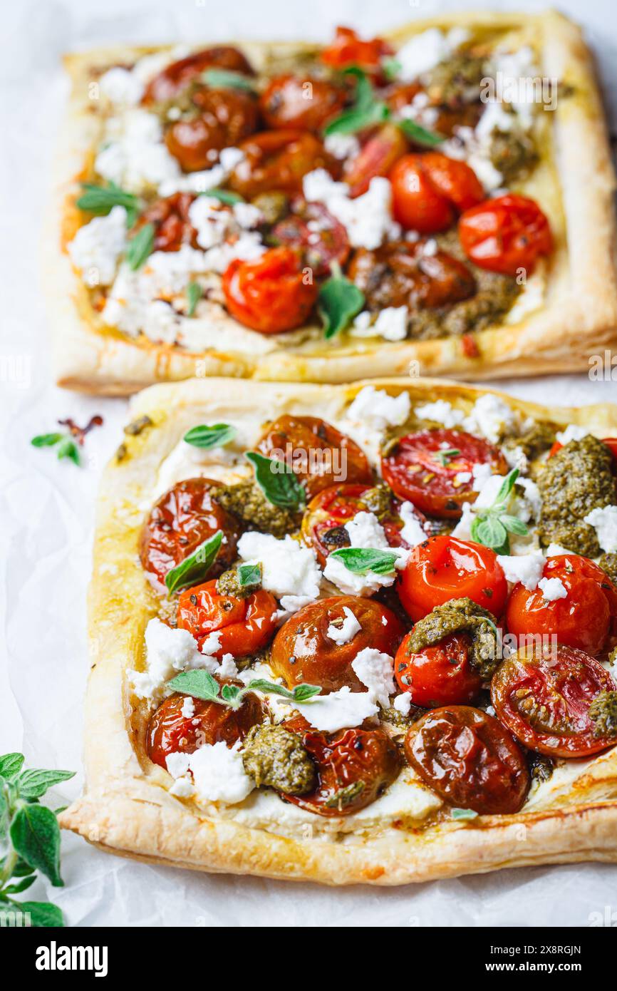 Pesto, tomato and feta tarts. Summer Italian recipe Stock Photo - Alamy