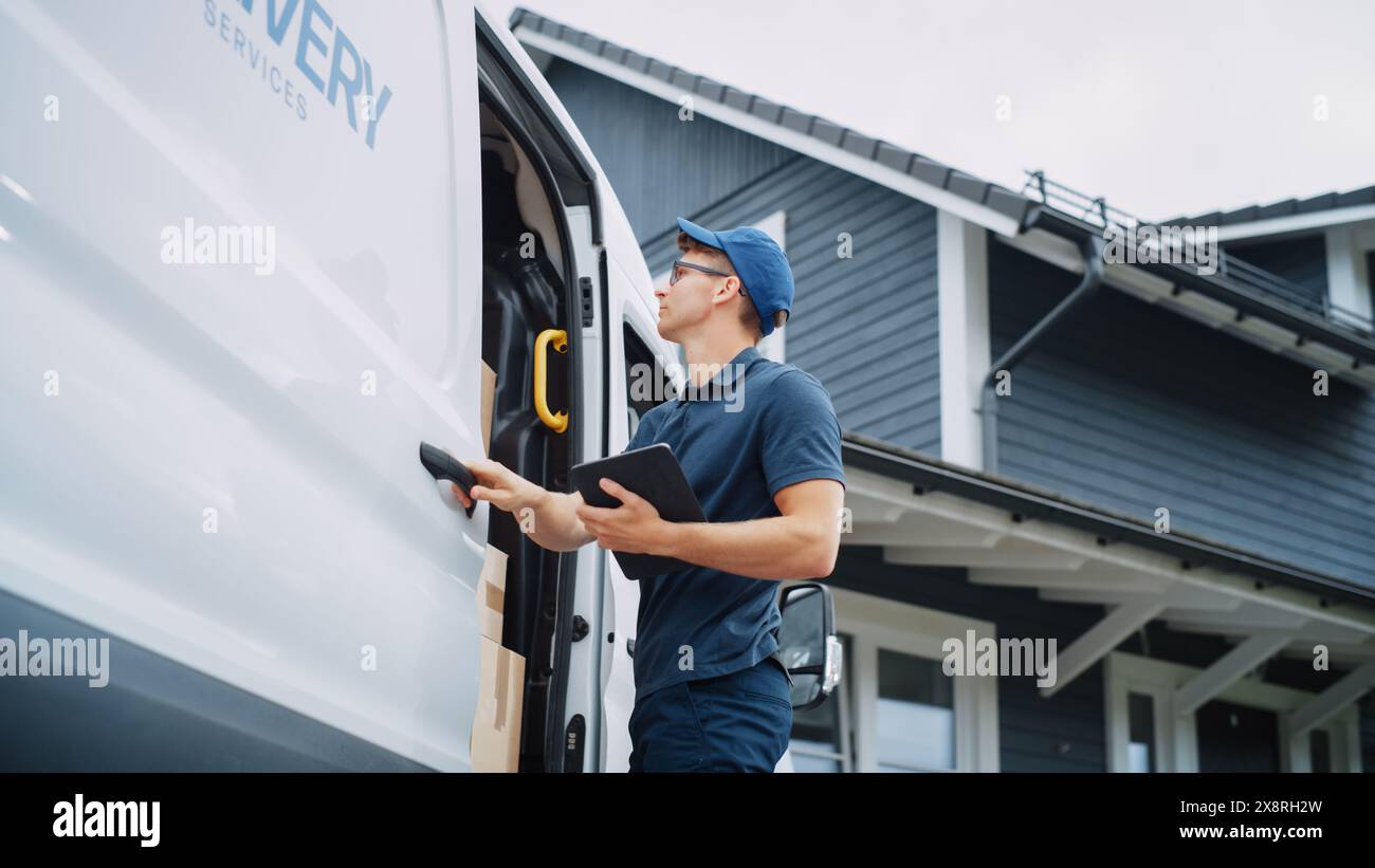 Courier Using Tablet Computer Next to Open Delivery Van Side Door with ...