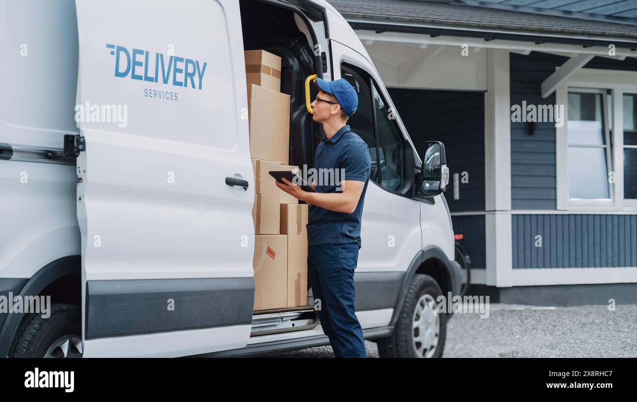 Courier Using Tablet Computer Next to Open Delivery Van Side Door with ...