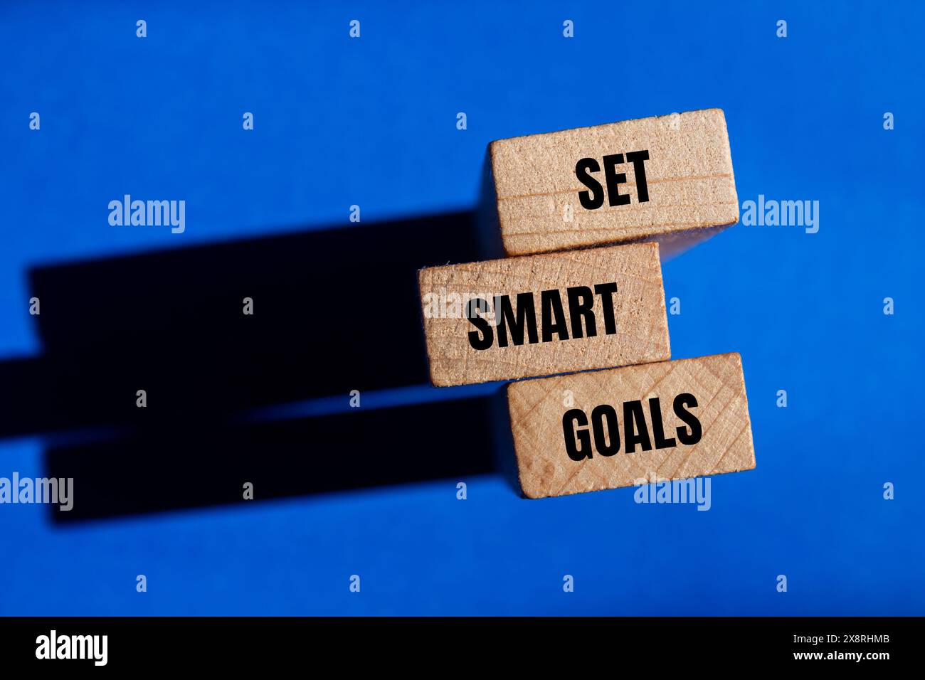 Set smart goals words written on wooden blocks with blue background ...