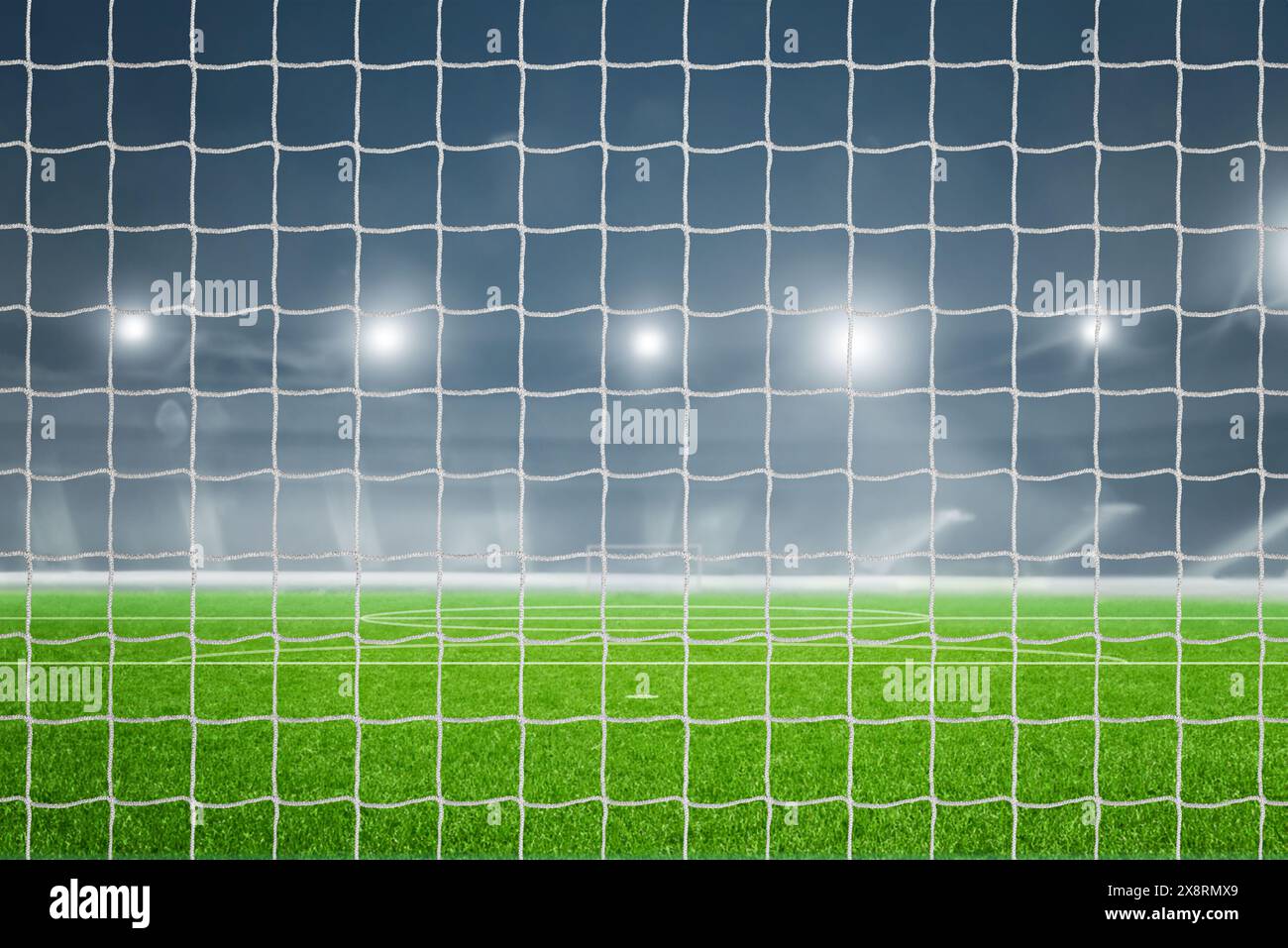 Goal net in a football stadium illuminated with lights, creating a ...
