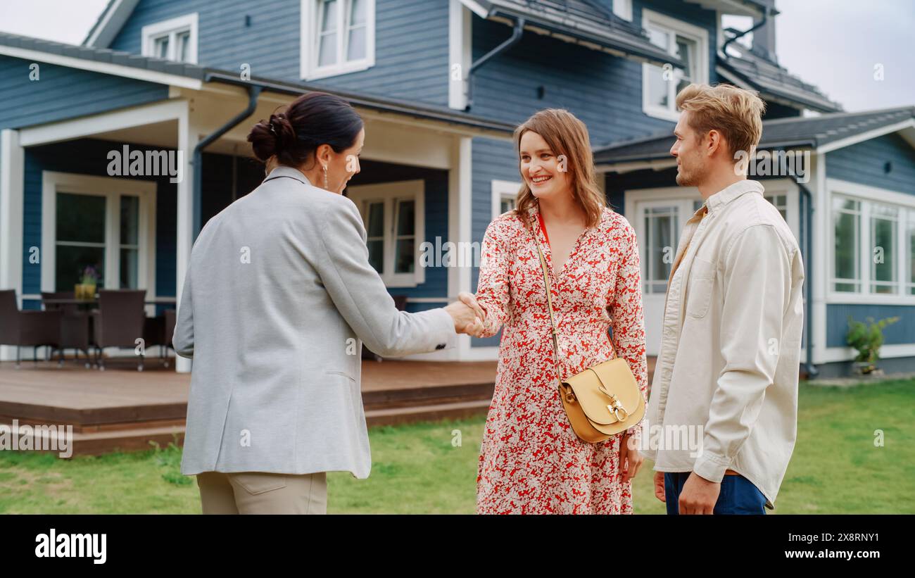 Happy Couple Shaking Hands with Realtor in Front of Their New Home ...