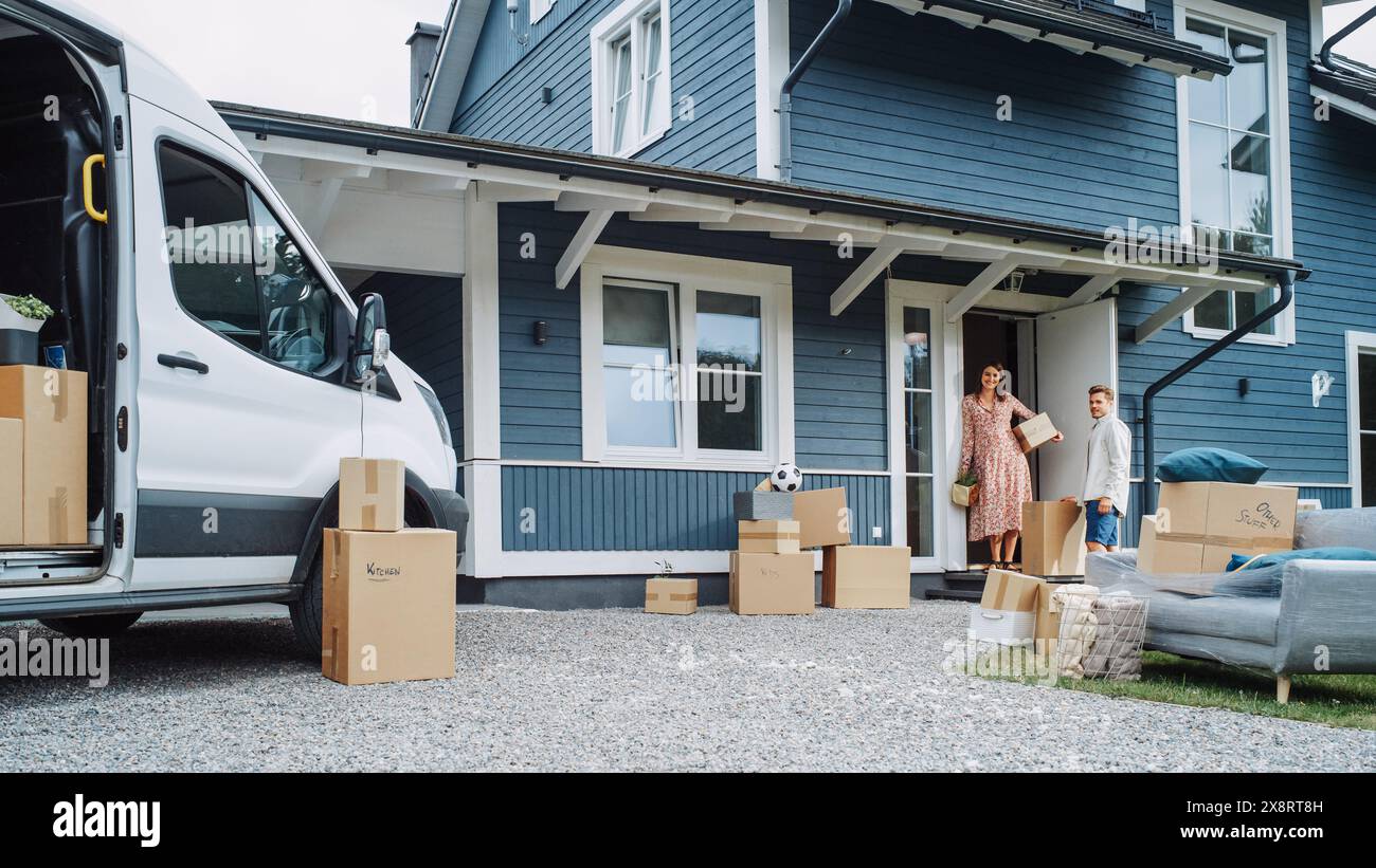 Young Family Moving to Their New Home in Residential Area. Handsome Man ...