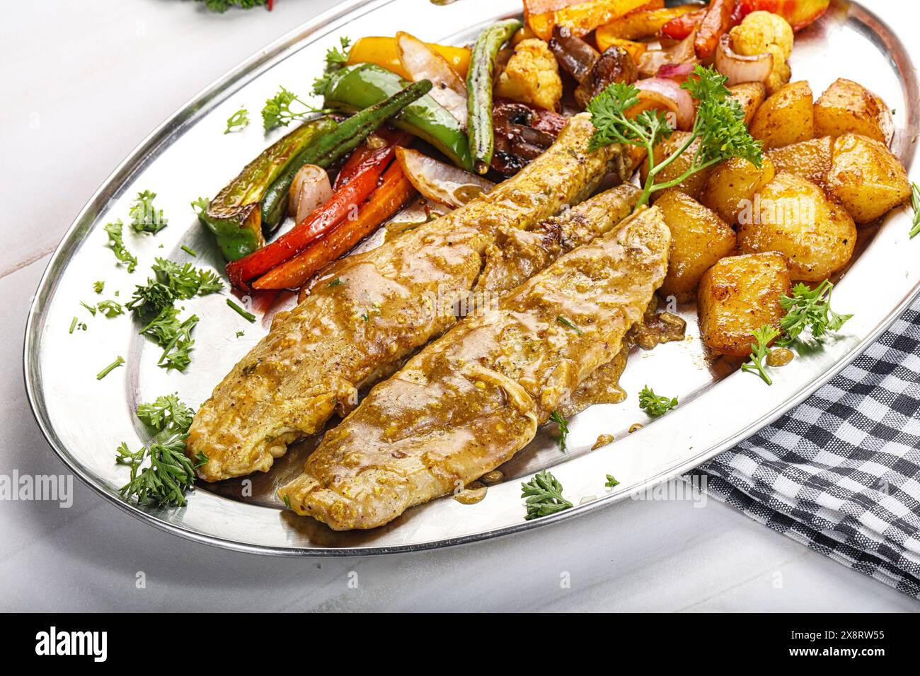 Roasted shark steak with potato and vegetable garnish Stock Photo - Alamy