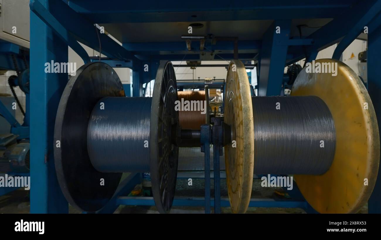 Rotating coils in industrial enterprise. Creative. Process of plastic ...