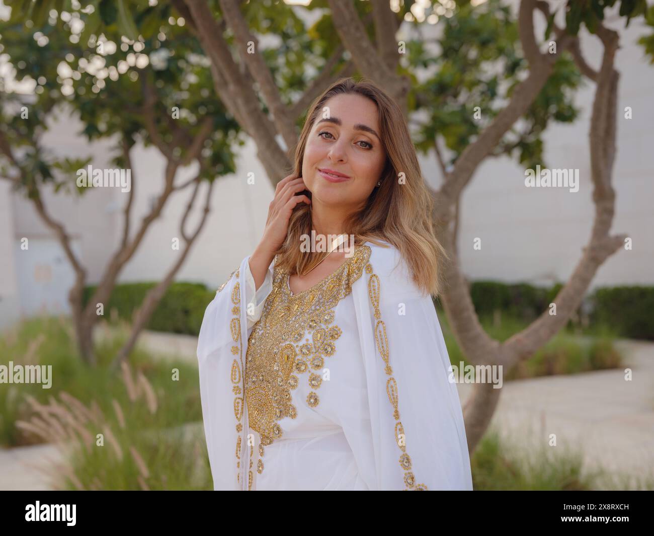 Travel to the United Arab Emirates, Abu Dhabi. Woman in white Arabic ...