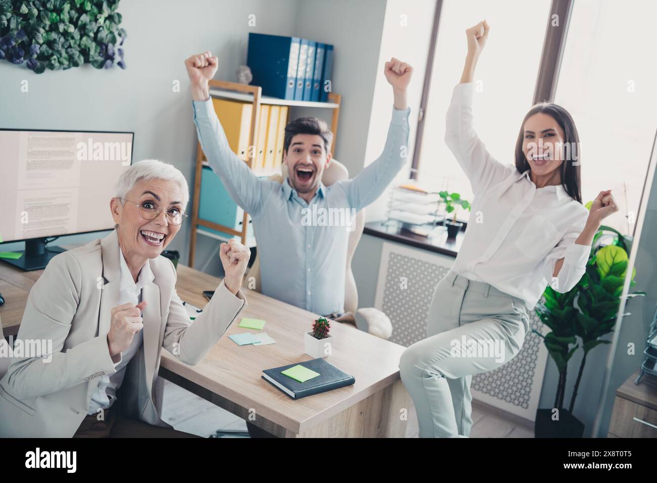 Photo of two employees mature boss woman winning office team meeting ...