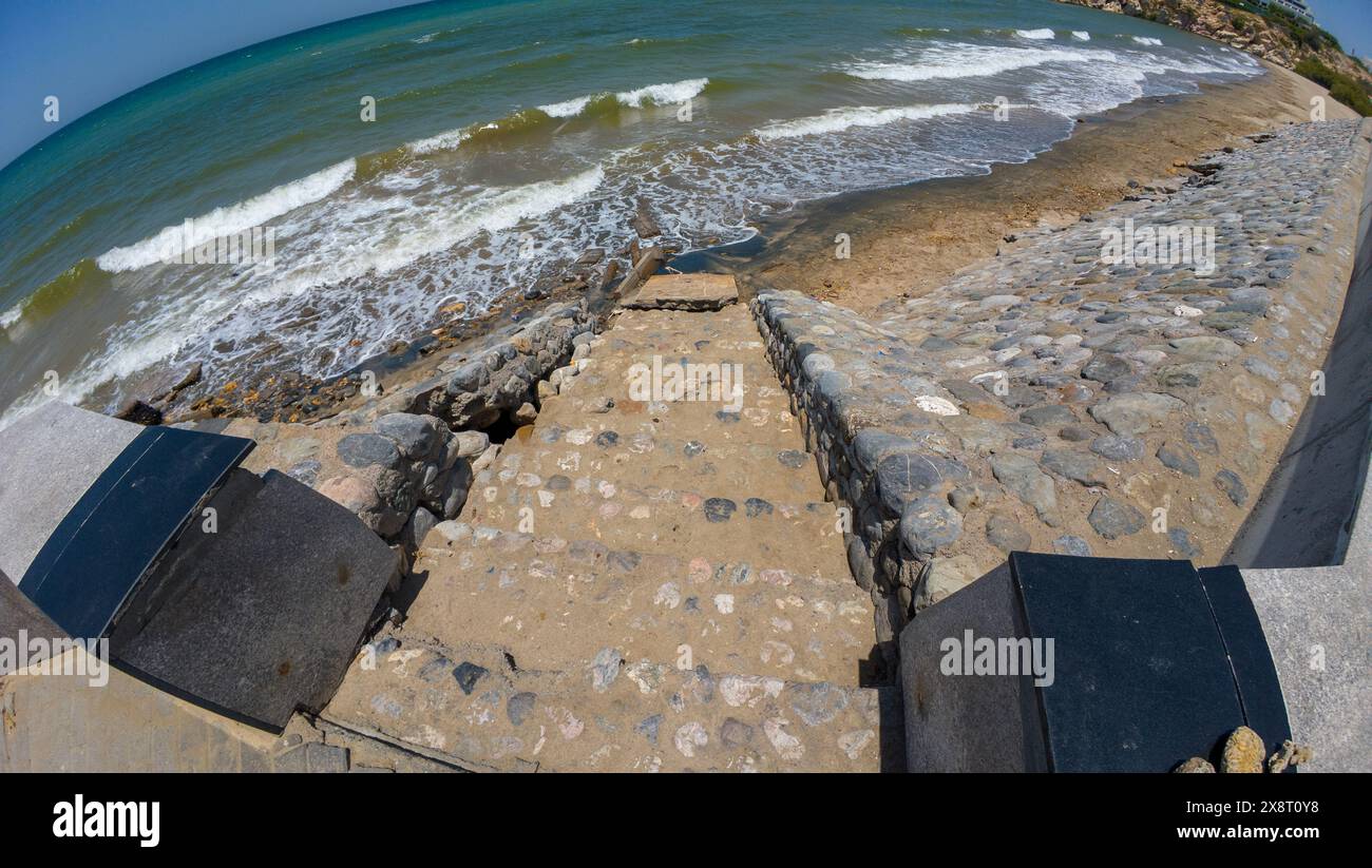 Photography of eroded tone wall and stairs going to beach and sea in ...