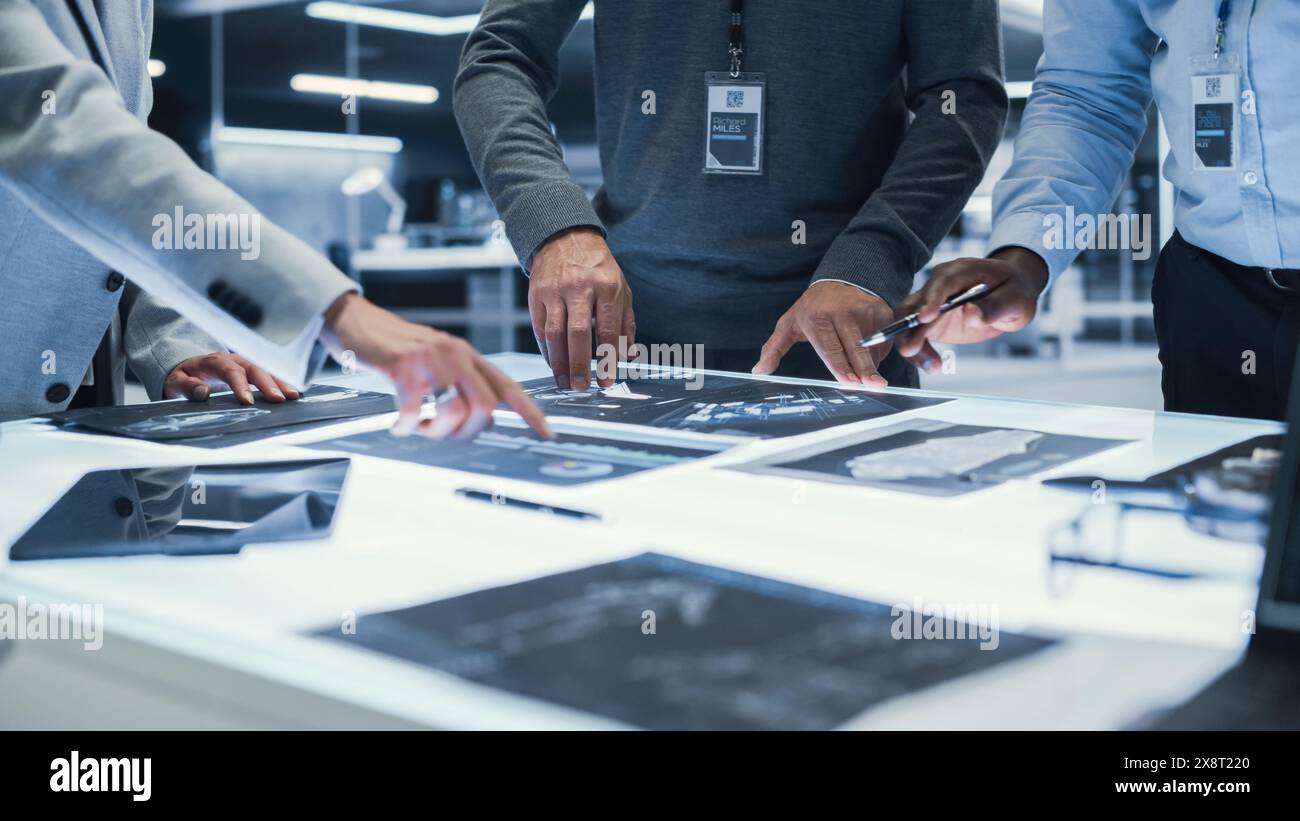 Anonymous Managers Standing Around a Table, Having a Work Meeting ...