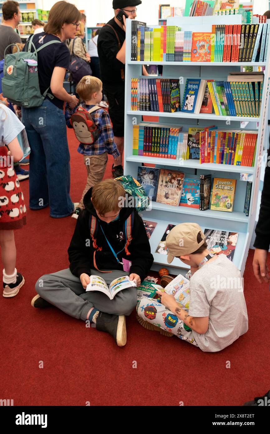 Children boys sitting on floor reading looking at books by kids book ...