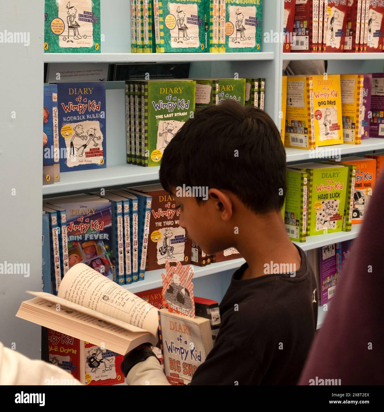 Young boy reading Diary of a Wimpy Kid book and Jeff Kinney books on ...