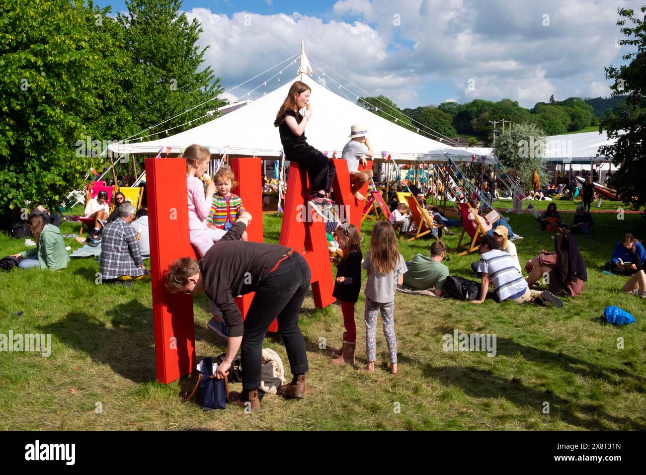 Children kids playing on the huge giant HAY sign people sitting by the ...