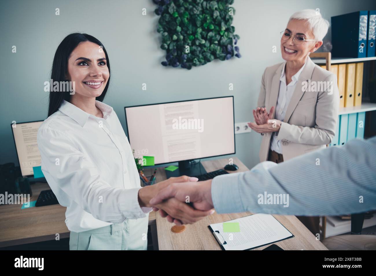Photo of two employees mature boss woman shake hands office team ...