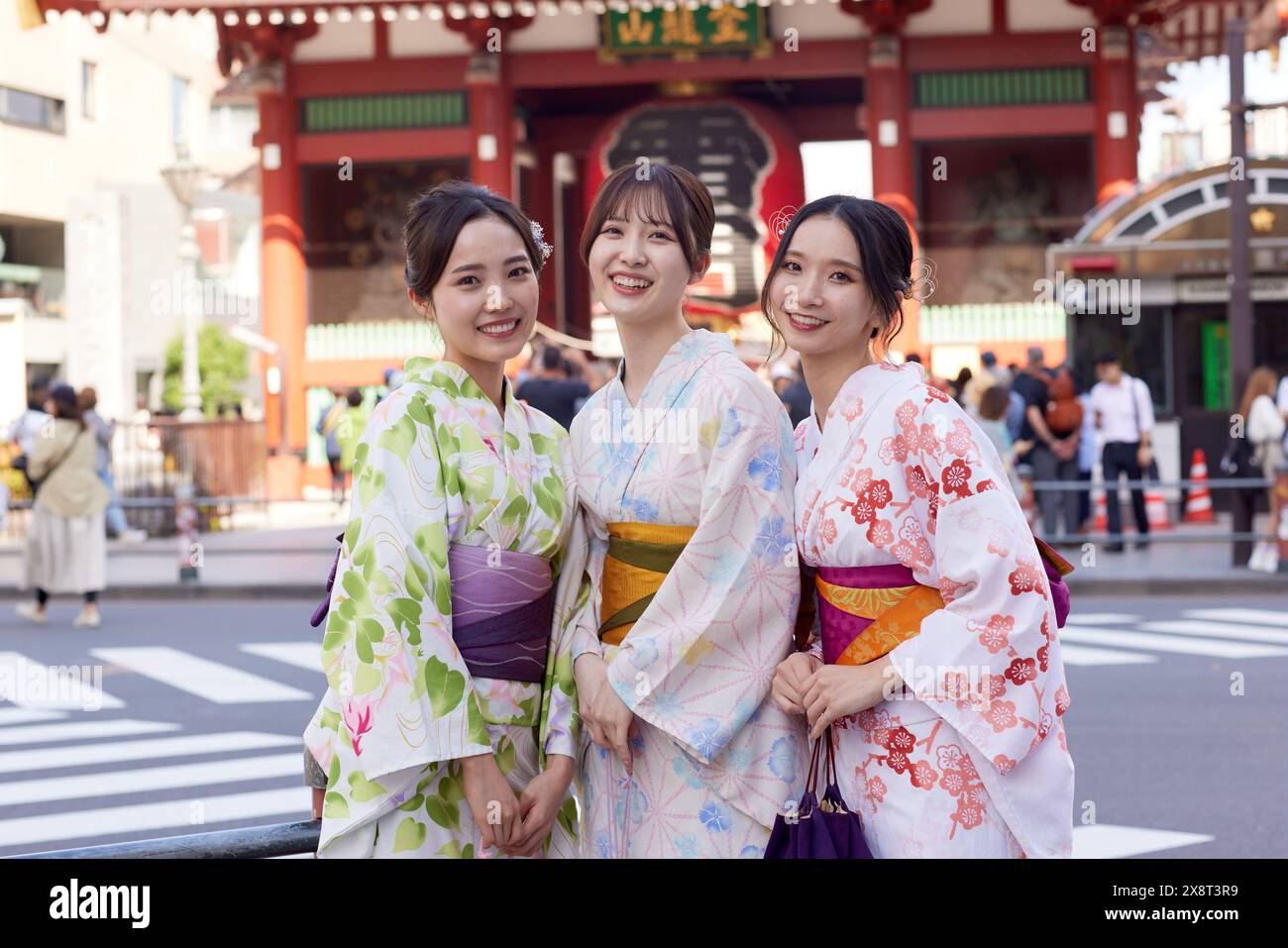 Japanese friends wearing yukata visiting traditional temple in Tokyo ...