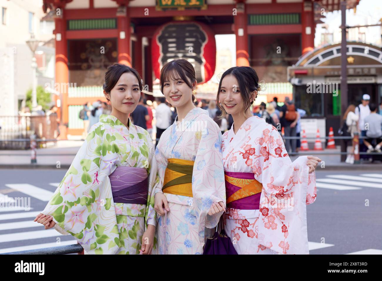 Japanese friends wearing yukata visiting traditional temple in Tokyo ...